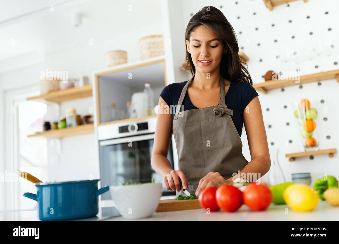 Happy woman making healthy food in kitchen Stock Photo - Alamy