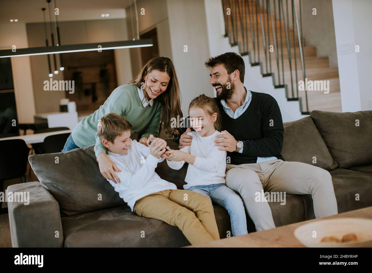 Cute siblings fighting over TV remote control at home Stock Photo - Alamy
