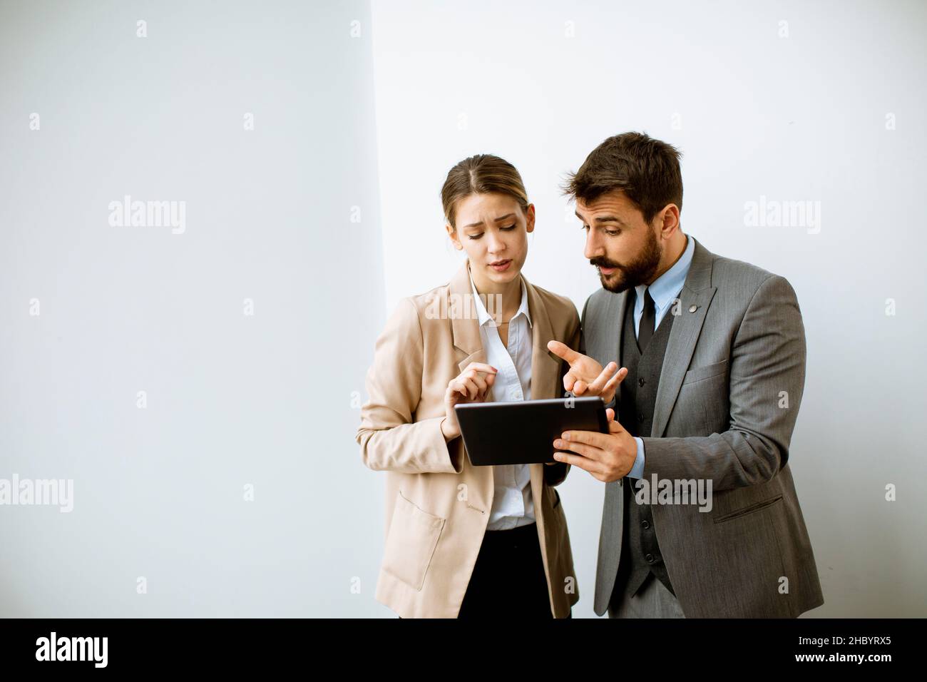 Young people with digital tablet by the wall in the modern office Stock ...