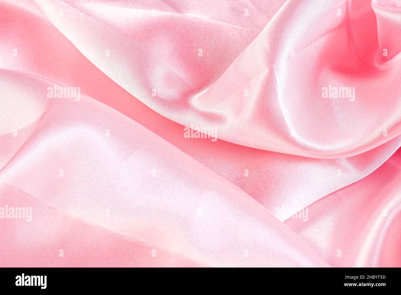 Light pastel pink color silk wavy textile pattern as a smooth textured ...