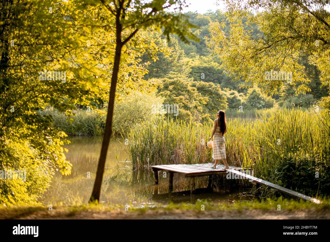 Female person walking lake pier hi-res stock photography and images - Alamy