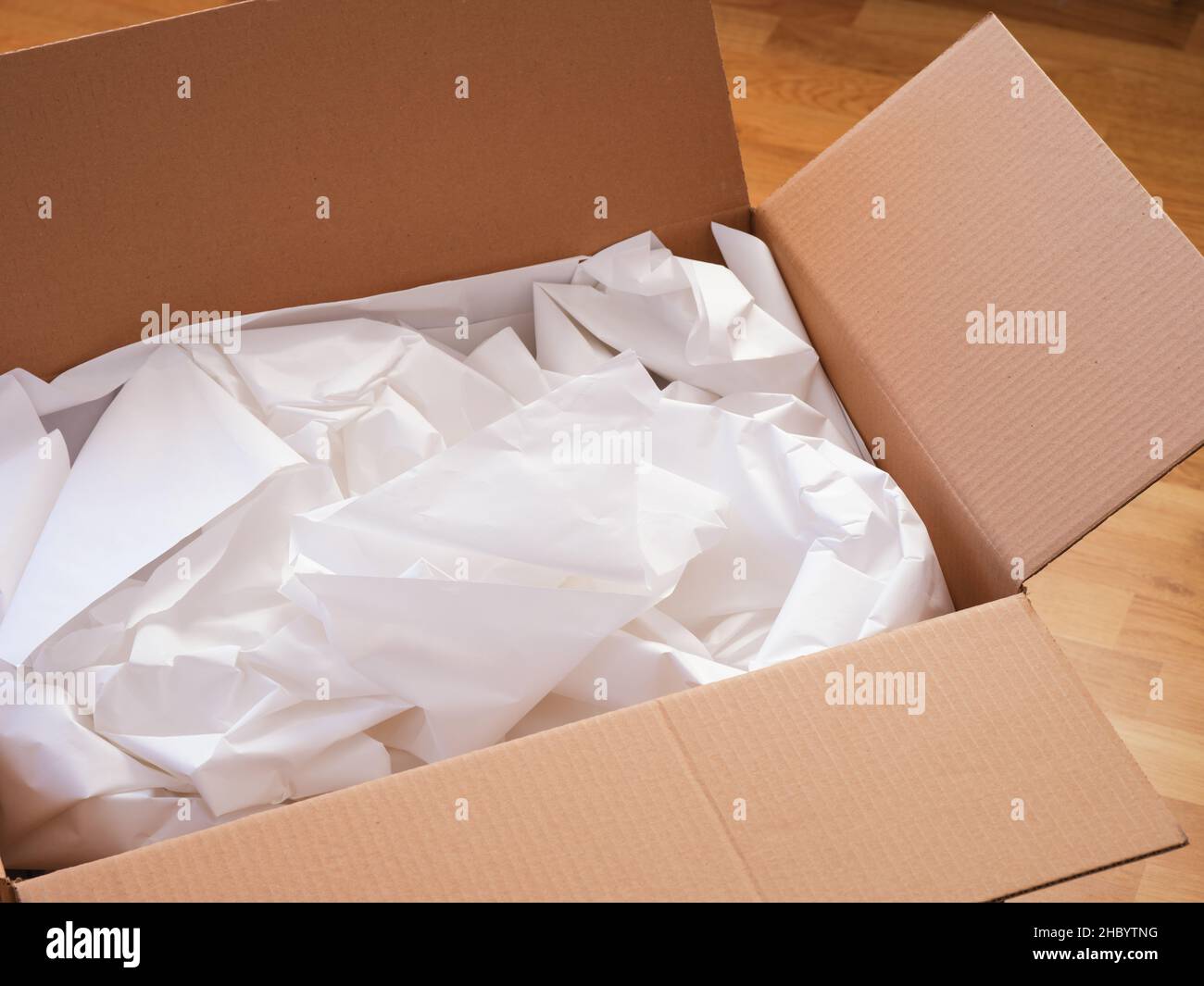 Crumpled paper in a cardboard box. Close up Stock Photo - Alamy