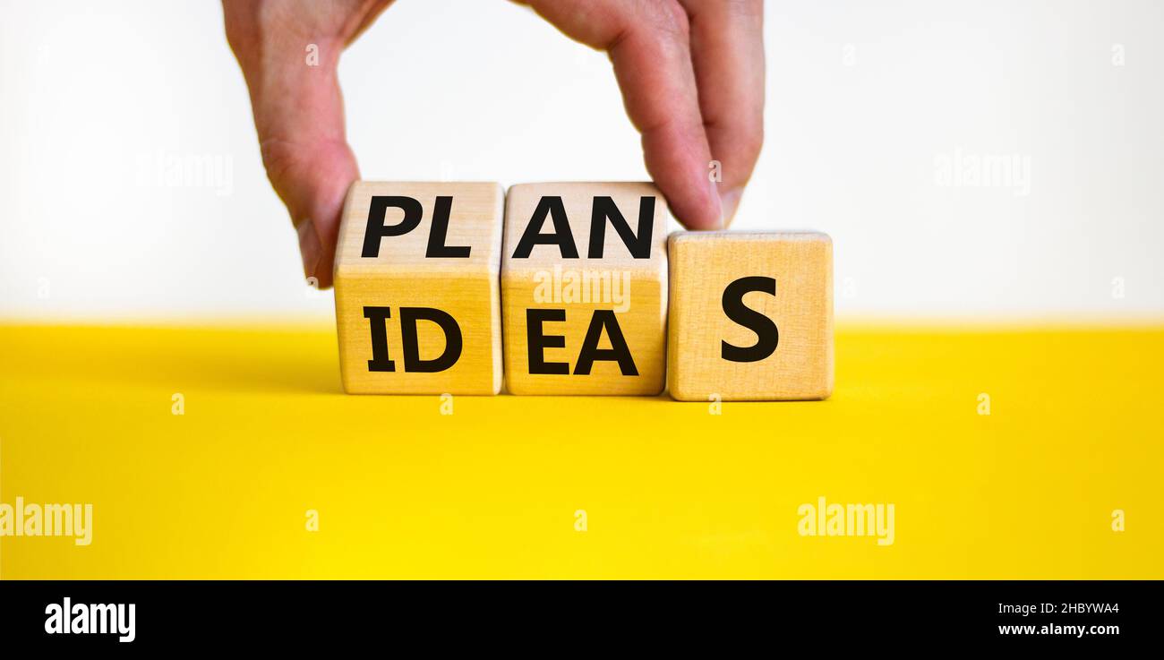 Ideas and plans symbol. Businessman turns wooden cubes and changes the ...