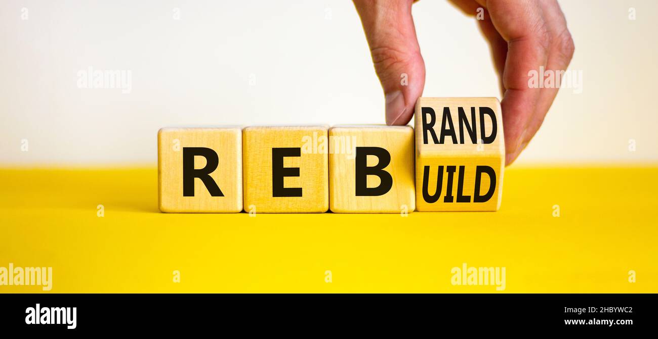 Rebrand and rebuild symbol. Businessman turnsa wooden cubes and changes ...