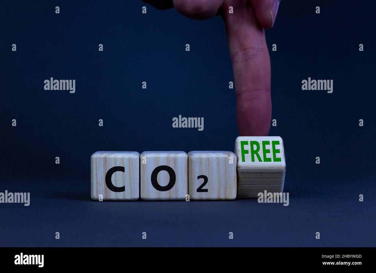 CO2 changes and free symbol. Businessman turns a wooden cube and ...
