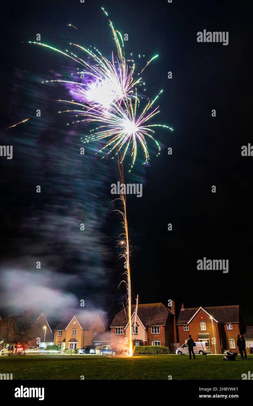 Firework display on village green with fireworks exploding on top of a ...