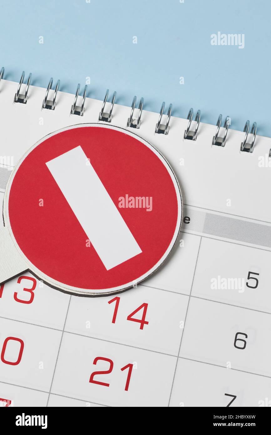 Close-up view of monthly calendar and No entry traffic sign. Symbol of ...