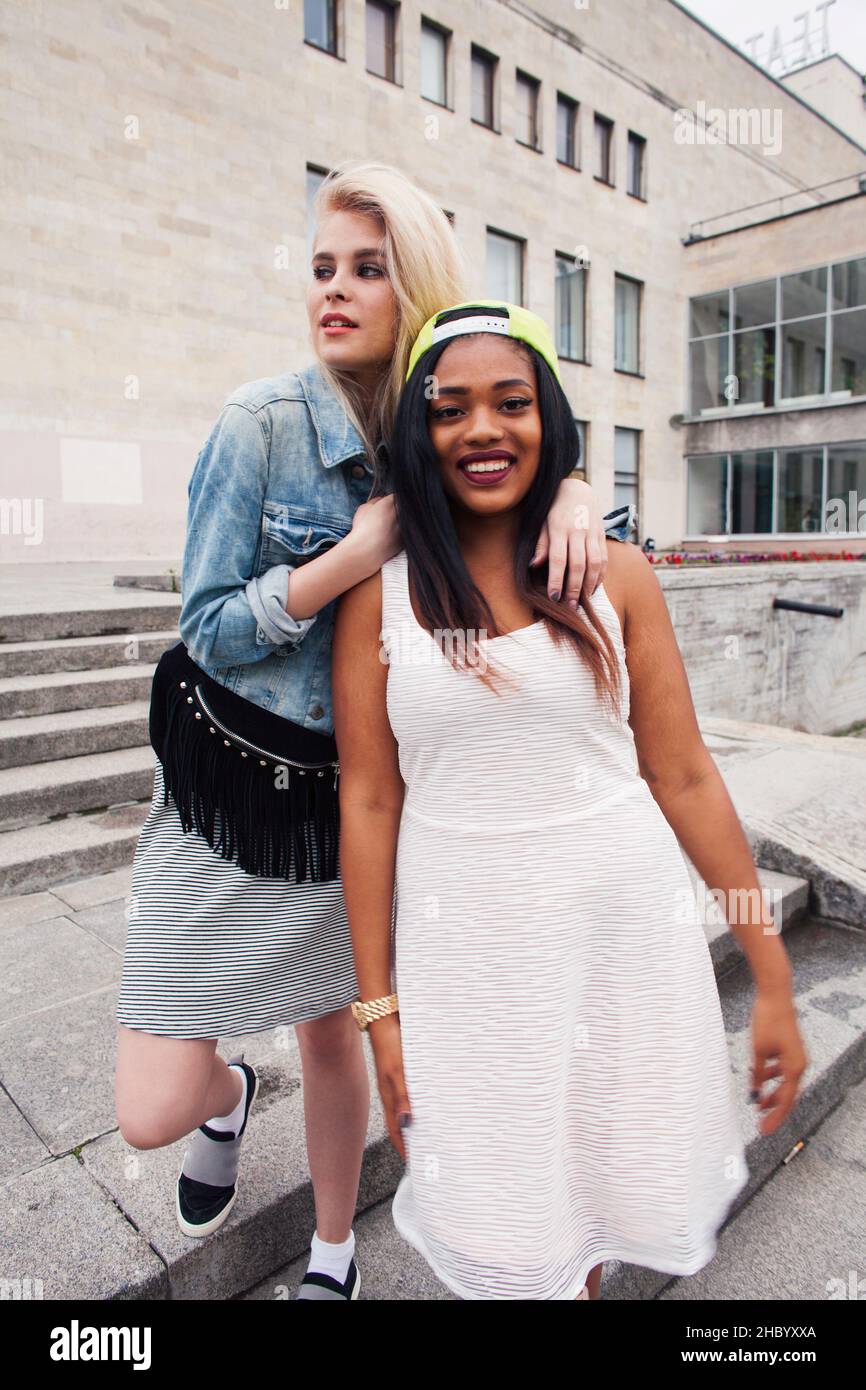 Two teenage diverse nations girls infront of university building ...
