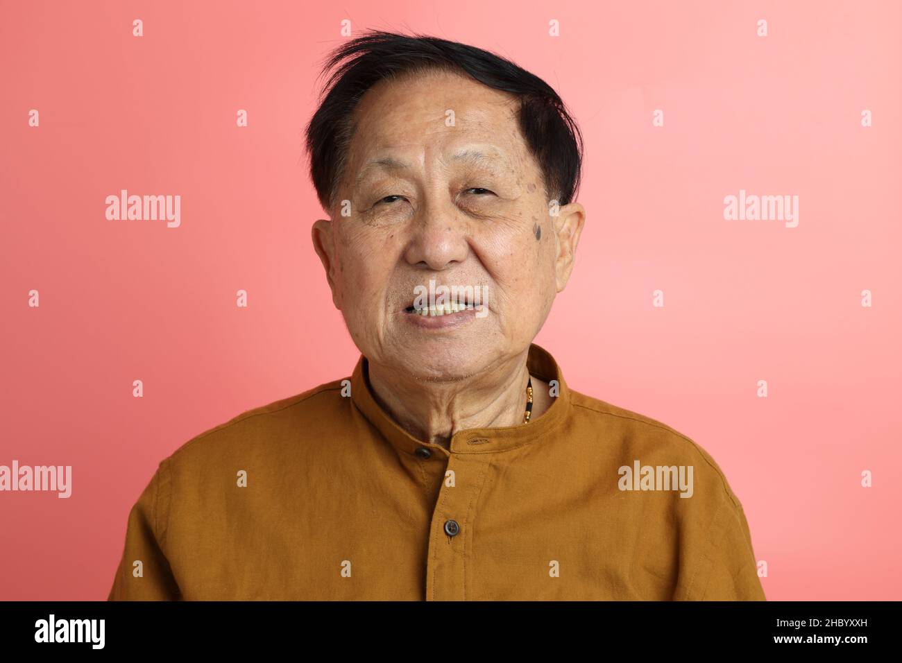 The senior Asian man portrait with no retouched skin in the pink ...