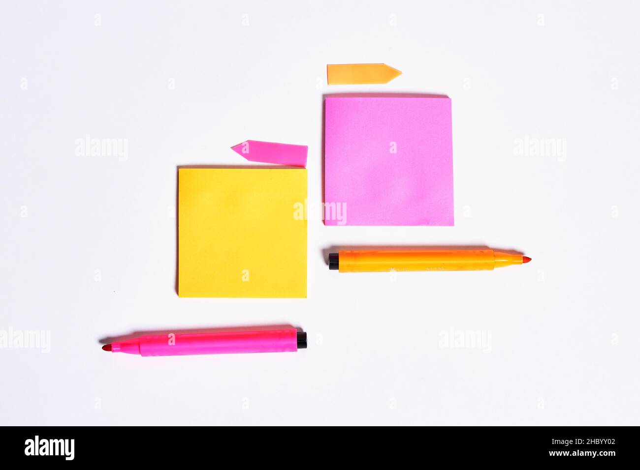 Colored sticky notes and markers with copy space on white background ...