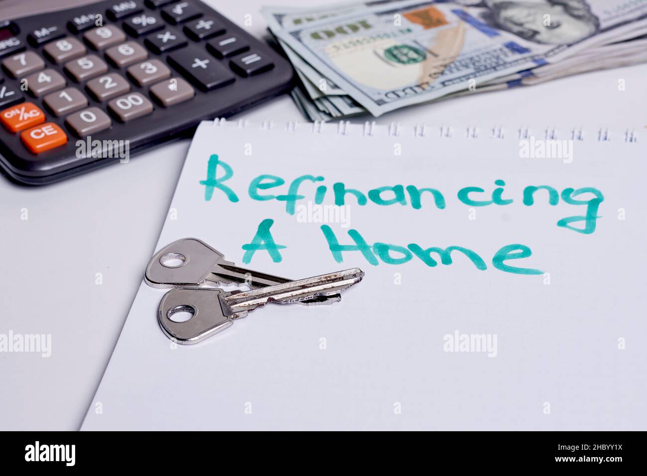 Refinancing a home concept. House keys, calculator and money Stock ...