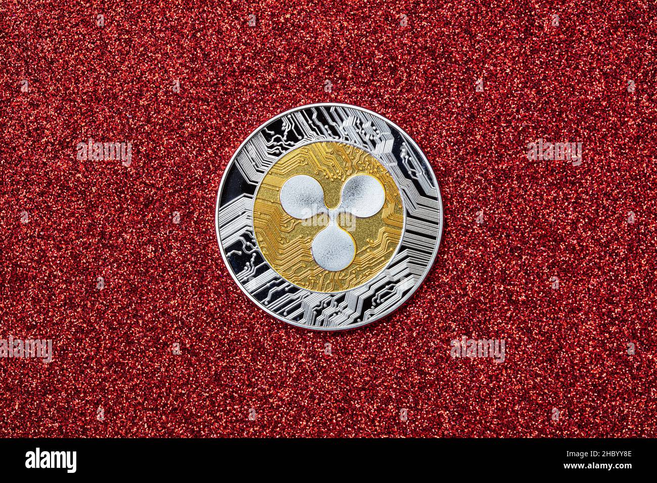 Ripple coin, XRP token, cryptocurrency on red background Stock Photo ...