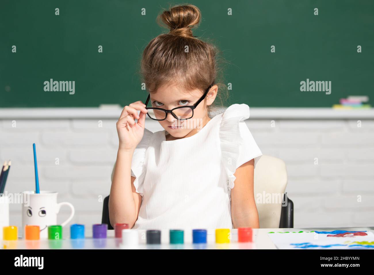 Child girl drawing with coloring pens paintind. Portrait of adorable ...