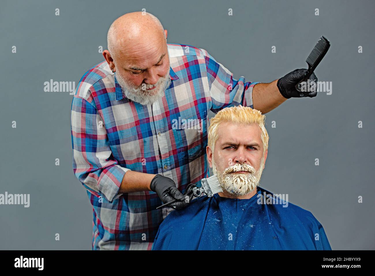 Hair coloring in gray color process. Hairdresser applying colorful tint ...