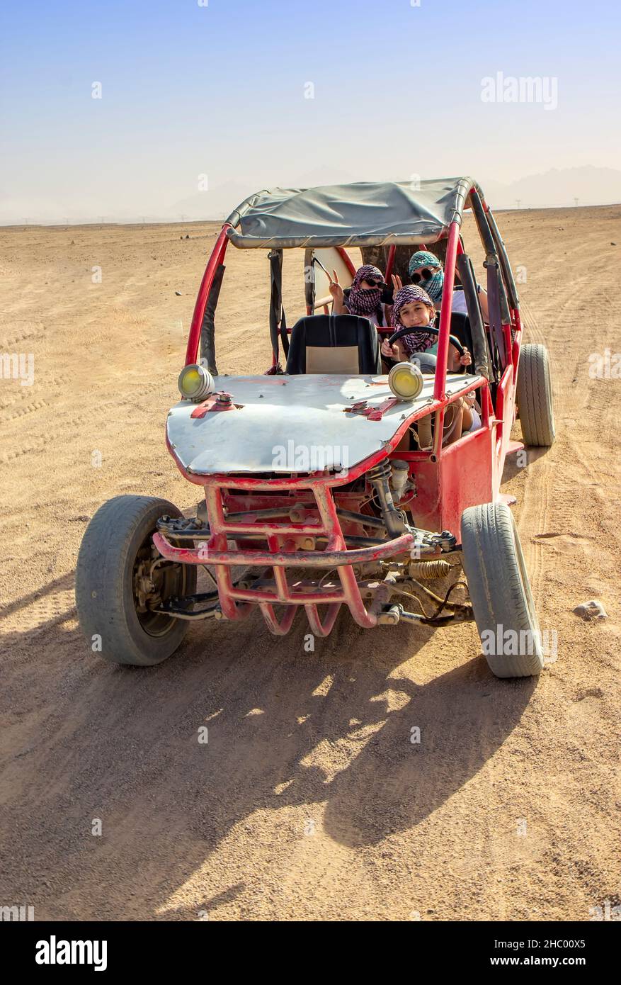 Girl driving buggy in the desert Stock Photo - Alamy