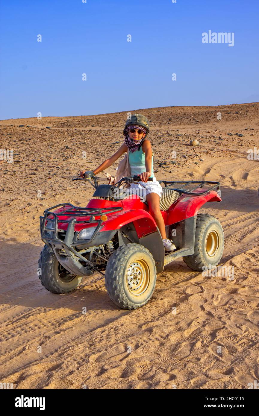 Girl driving ATV in the desert Stock Photo - Alamy