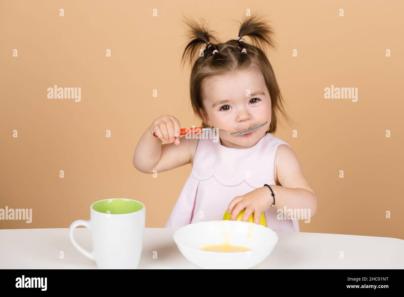 Babies eating, healthy food for a baby. Little baby eating fruit puree ...