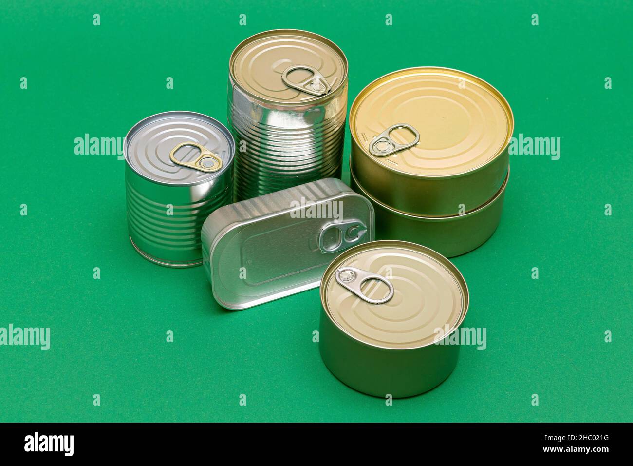 A Group of Stacked Tin Cans with Blank Edges on Green Background ...