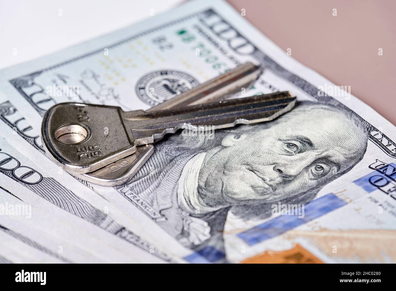 Metallic keys and us dollars. Pay for home rent concept. House keys ...