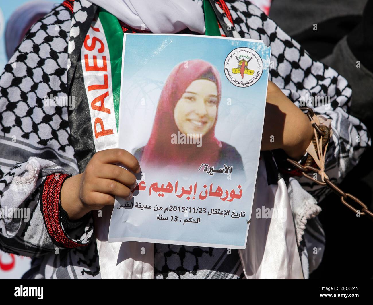 A Palestinian woman holds a poster of a prisoner Nourhan Awad during a ...