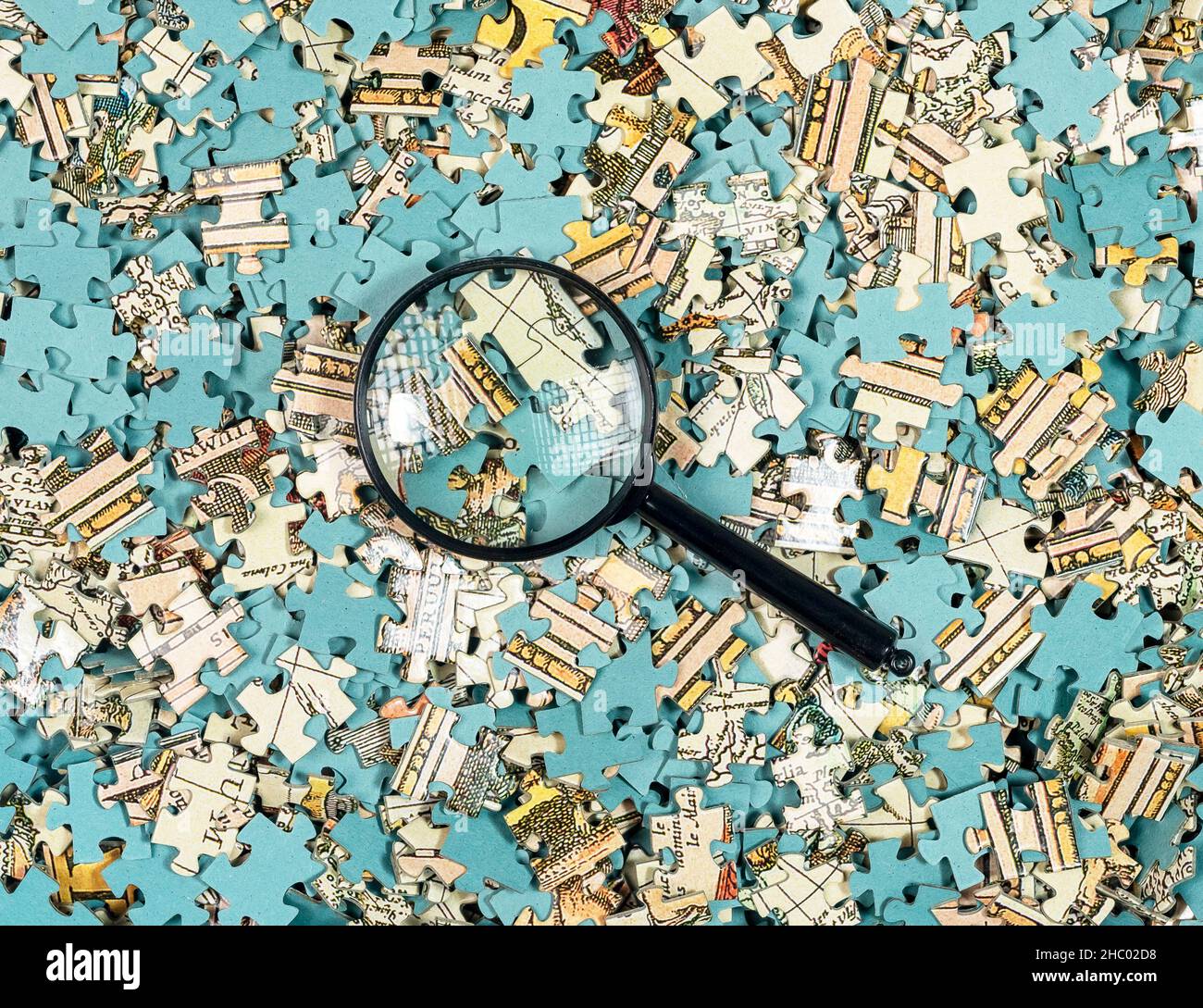 Puzzle pieces mess and chaos through magnifying glass. Missing jigsaw ...