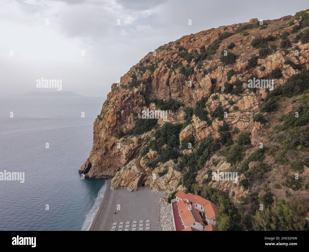 Aerial drone. Capo Calava bay and beach, with several holiday parks and ...