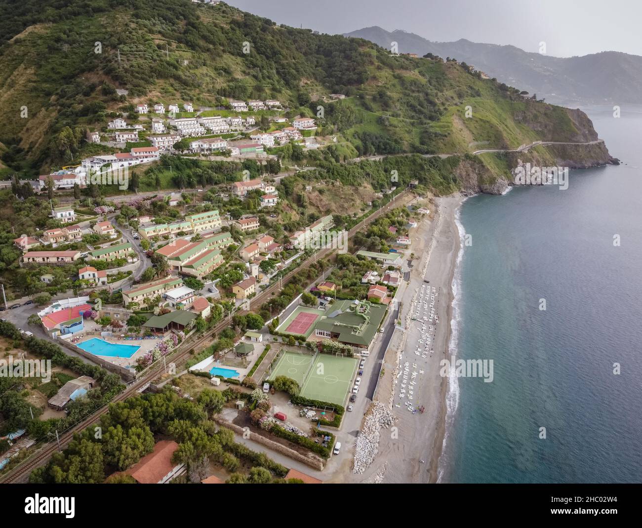 Aerial drone. Capo Calava bay and beach, with several holiday parks and ...
