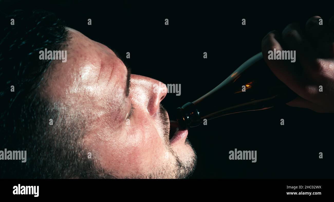 Upset man drinker alcoholic with glass drinking whiskey alone, sad ...