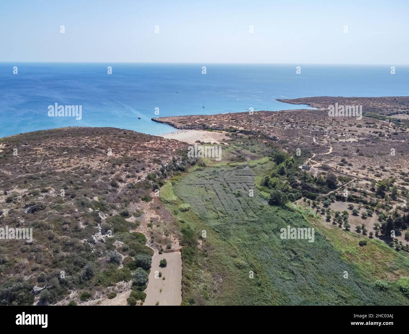 Aerial drone. Crystal clear turquoise waters at Calamosche, one of the ...