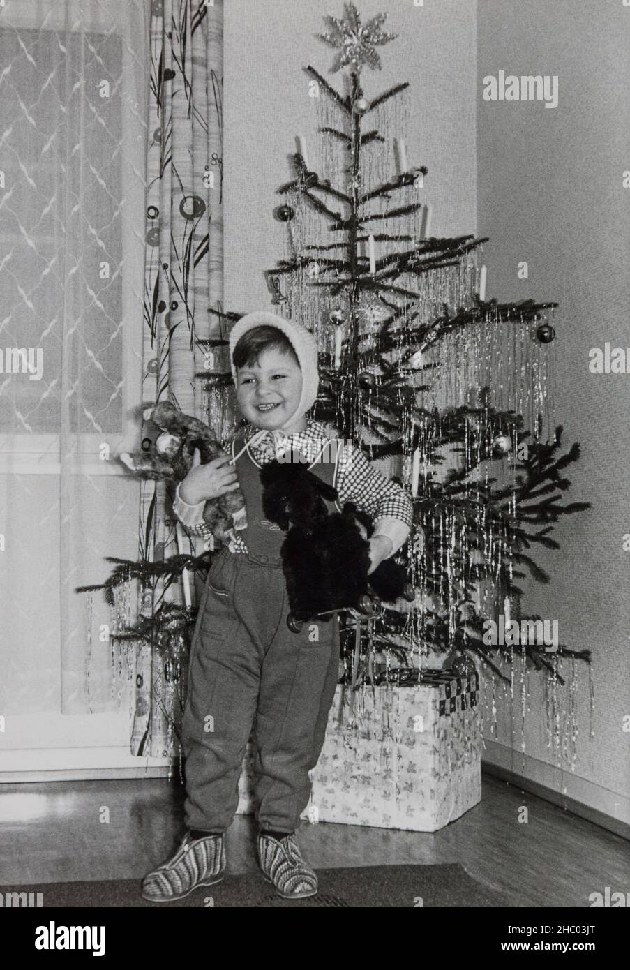 Christmas 1962 in Germany. A child is happy about his Christmas ...