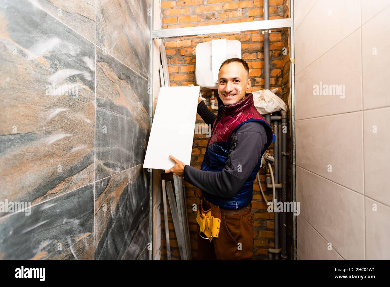 industrial tiler builder worker installing floor tile at repair ...