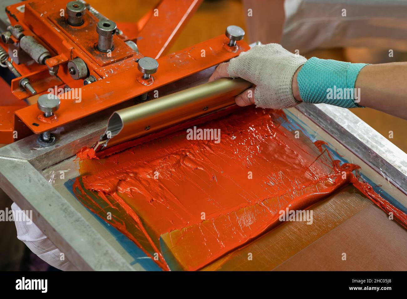 male hand with a squeegee. serigraphy production selective focus photo ...