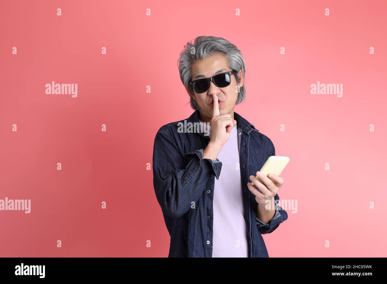 The Asian man standing on the pink background Stock Photo - Alamy