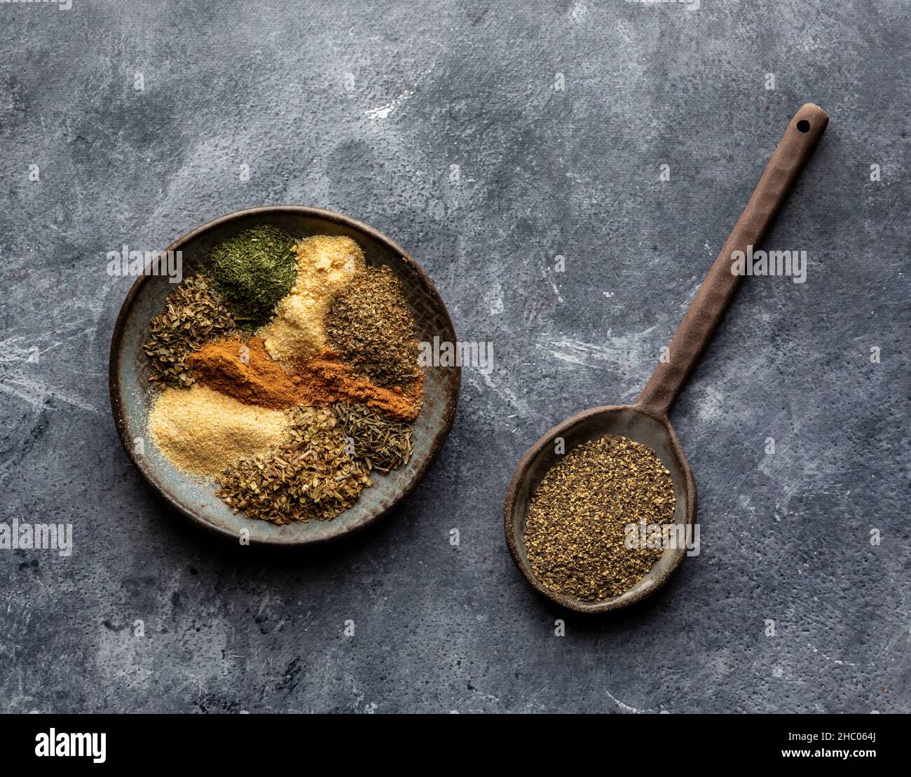 Top down view of a variety of dry spices used to make a spice blend ...