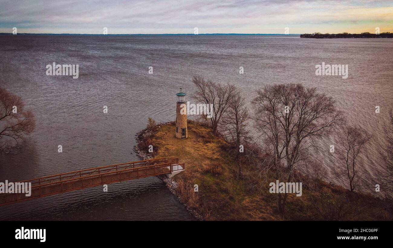 Old lighthouse on island looks out towards lake Stock Photo - Alamy