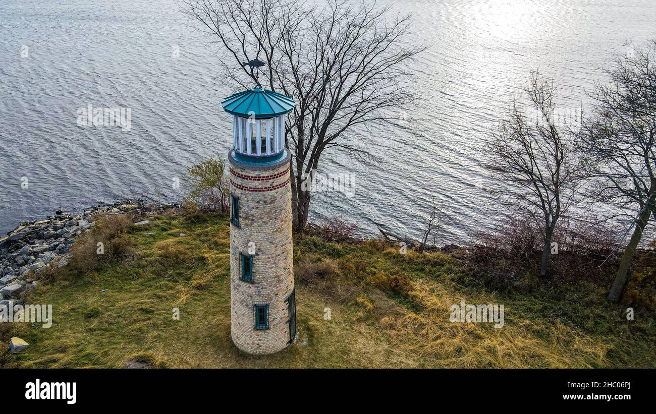 Old lighthouse on island looks out towards lake Stock Photo - Alamy