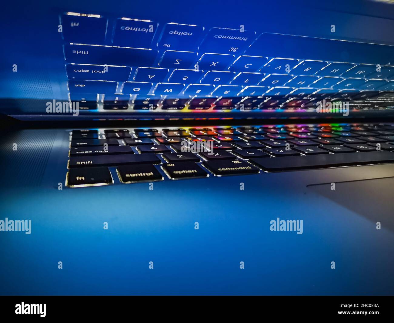 Colorful reflection of keyboard in dark screen of laptop Stock Photo ...