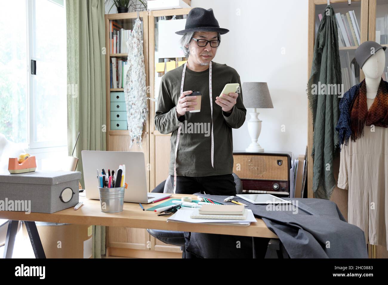 The senior Asian designer working in the studio Stock Photo - Alamy