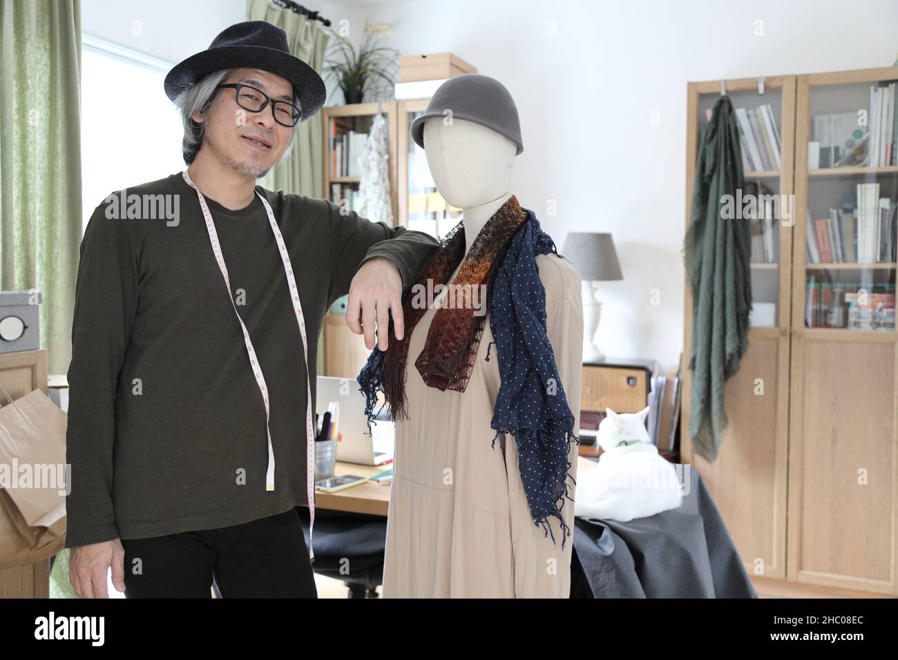 The senior Asian designer working in the studio Stock Photo - Alamy