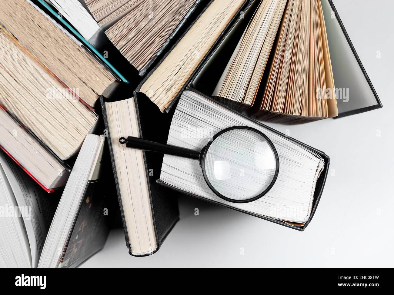 Magnifying lens over different books. Concept of focusing on knowledge ...