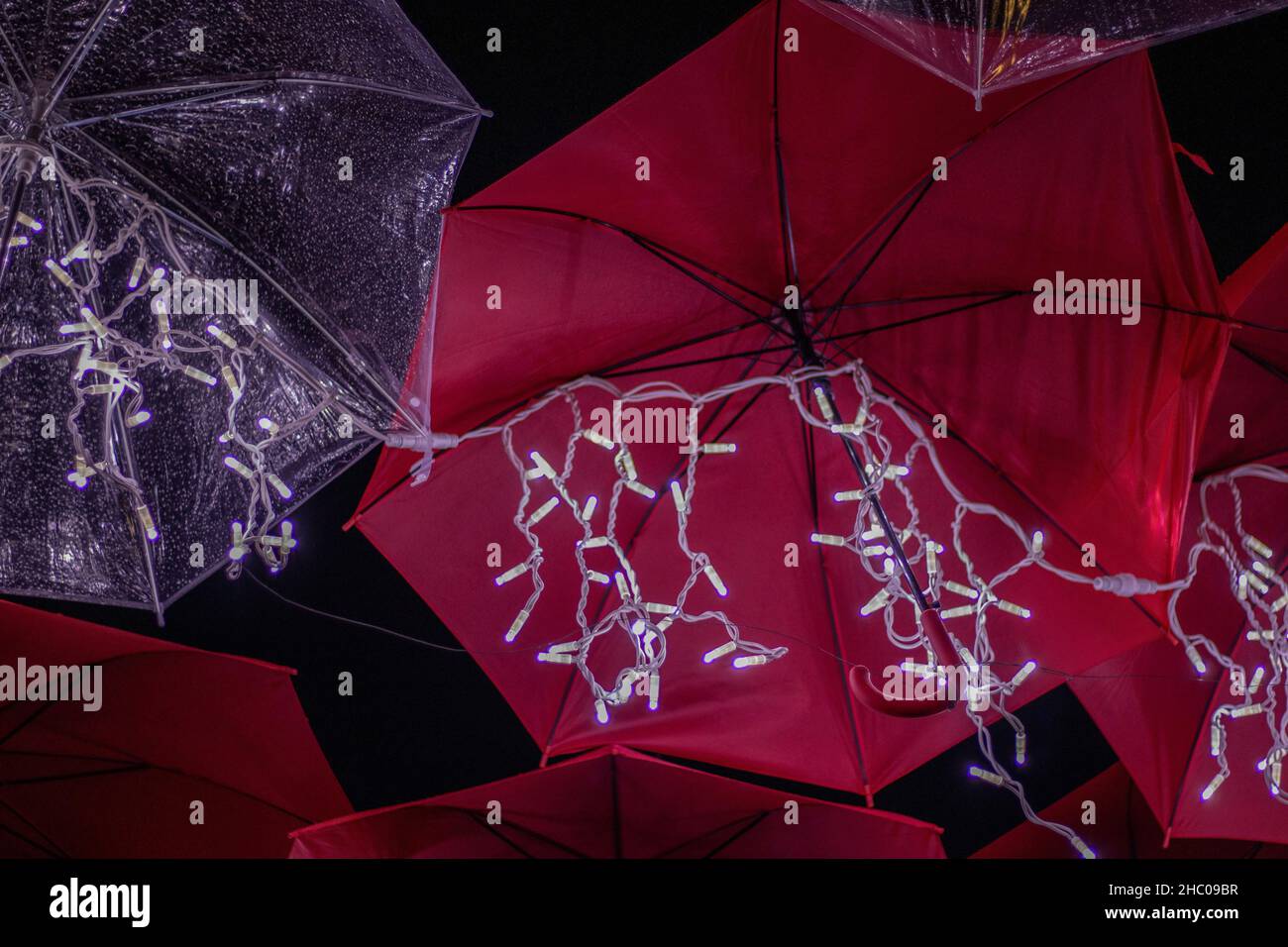 Red and white umbrellas, with Christmas lights, street decoration Stock ...
