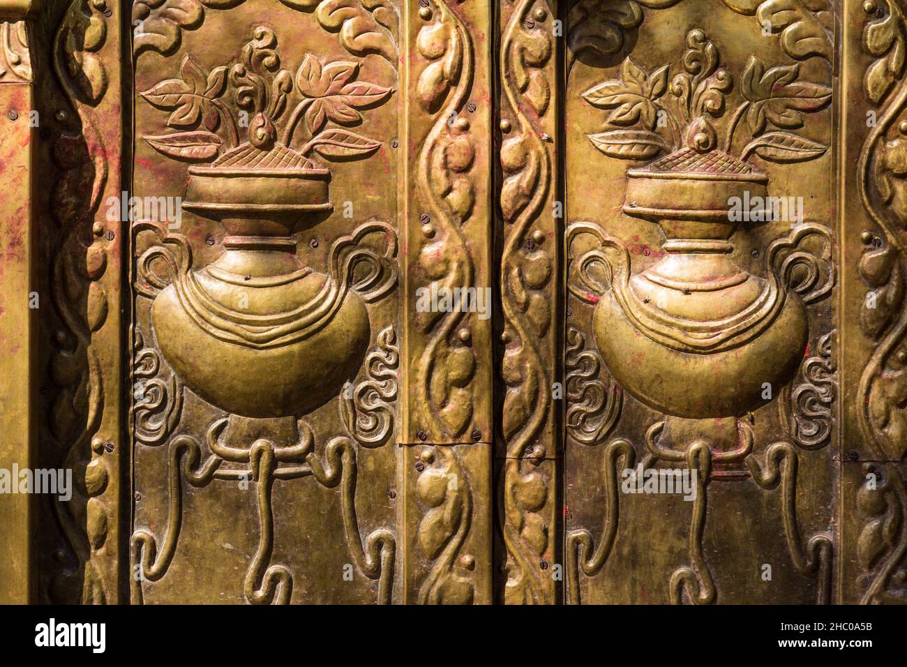 A treasure vase embossed on the copper doors of the Ganesh Mandir ...