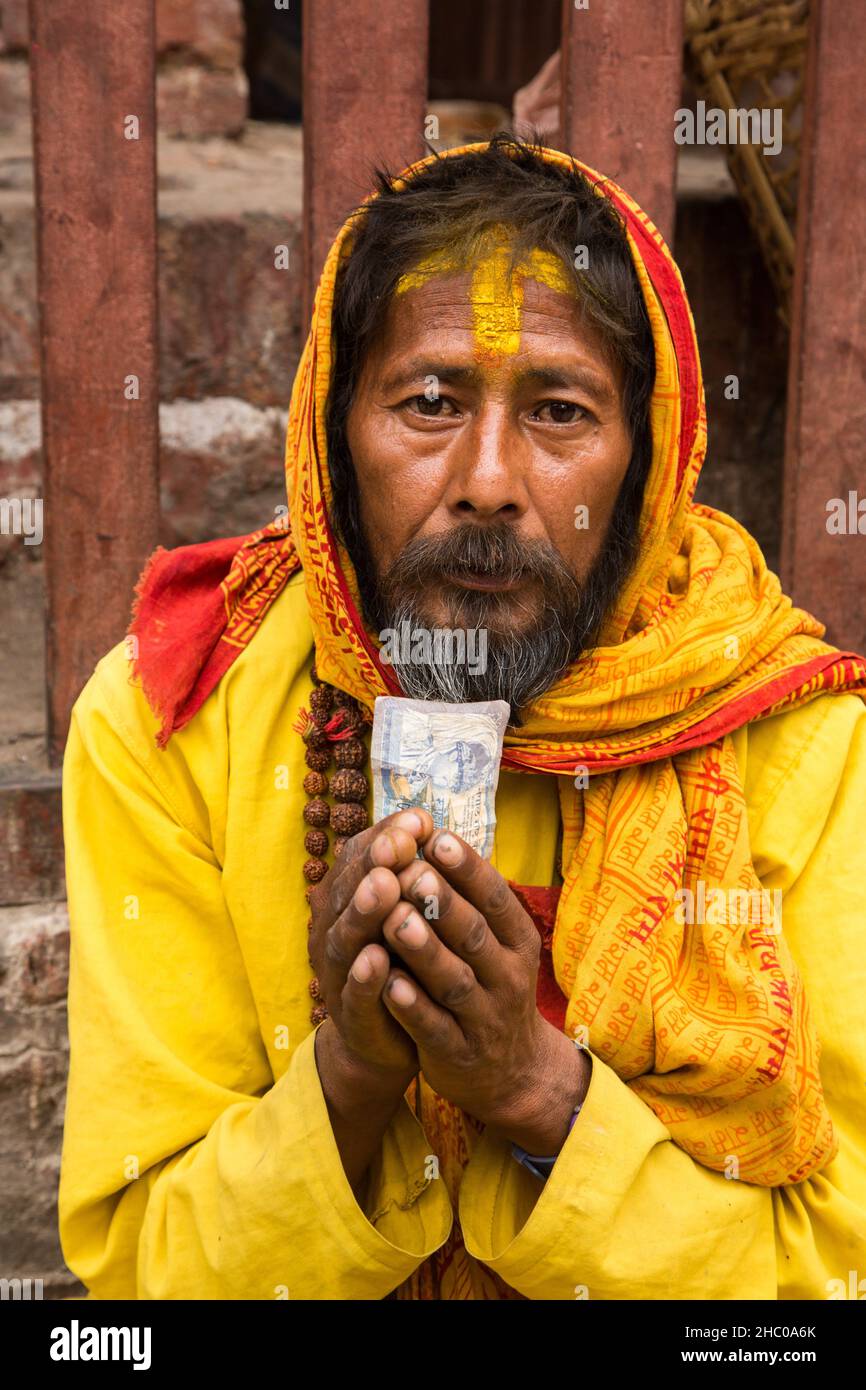 A sadhu, Hindu ascetic or holy man begging for alms in Hanuman Dhoka ...
