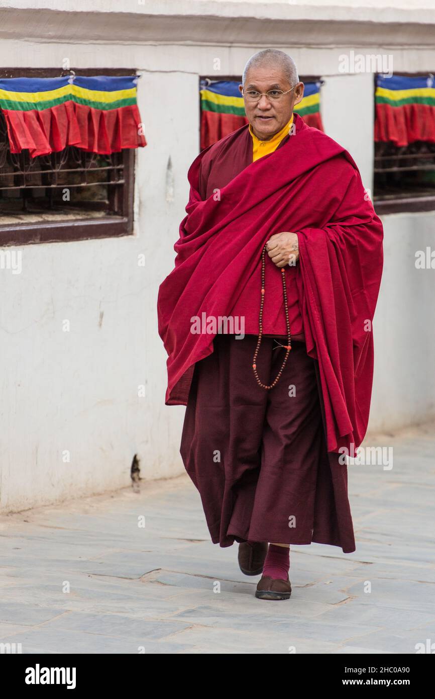 An older Buddhist monk with mala rosary beads circumambulates around ...