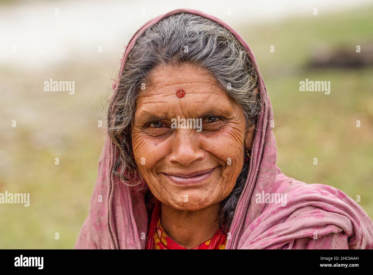 Portrait of an older Nepali Hindu woman with a tika or bindi on her ...