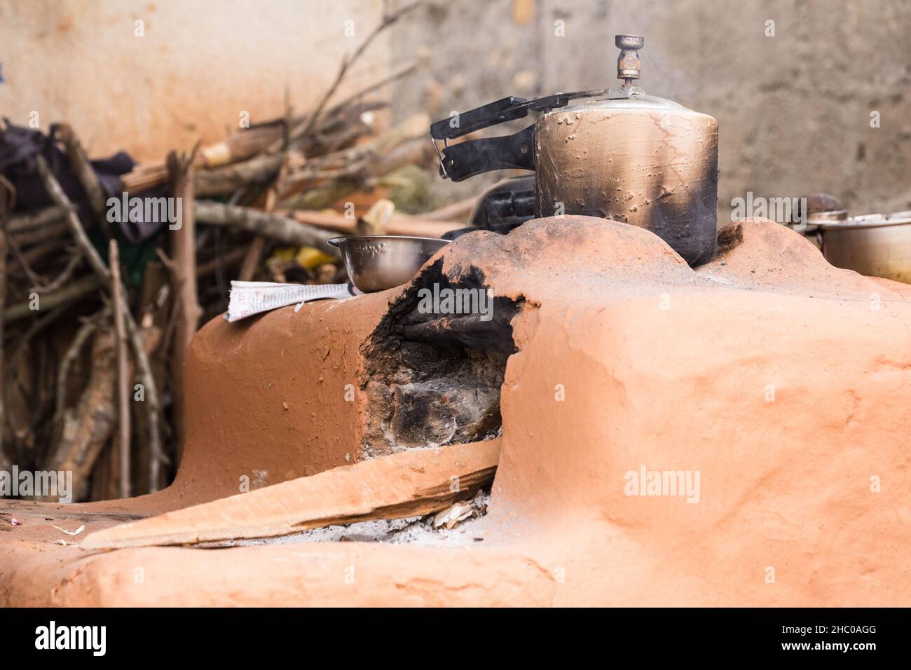 A pressure-cooking pot on top of a chulo or traditional outdoor wood ...