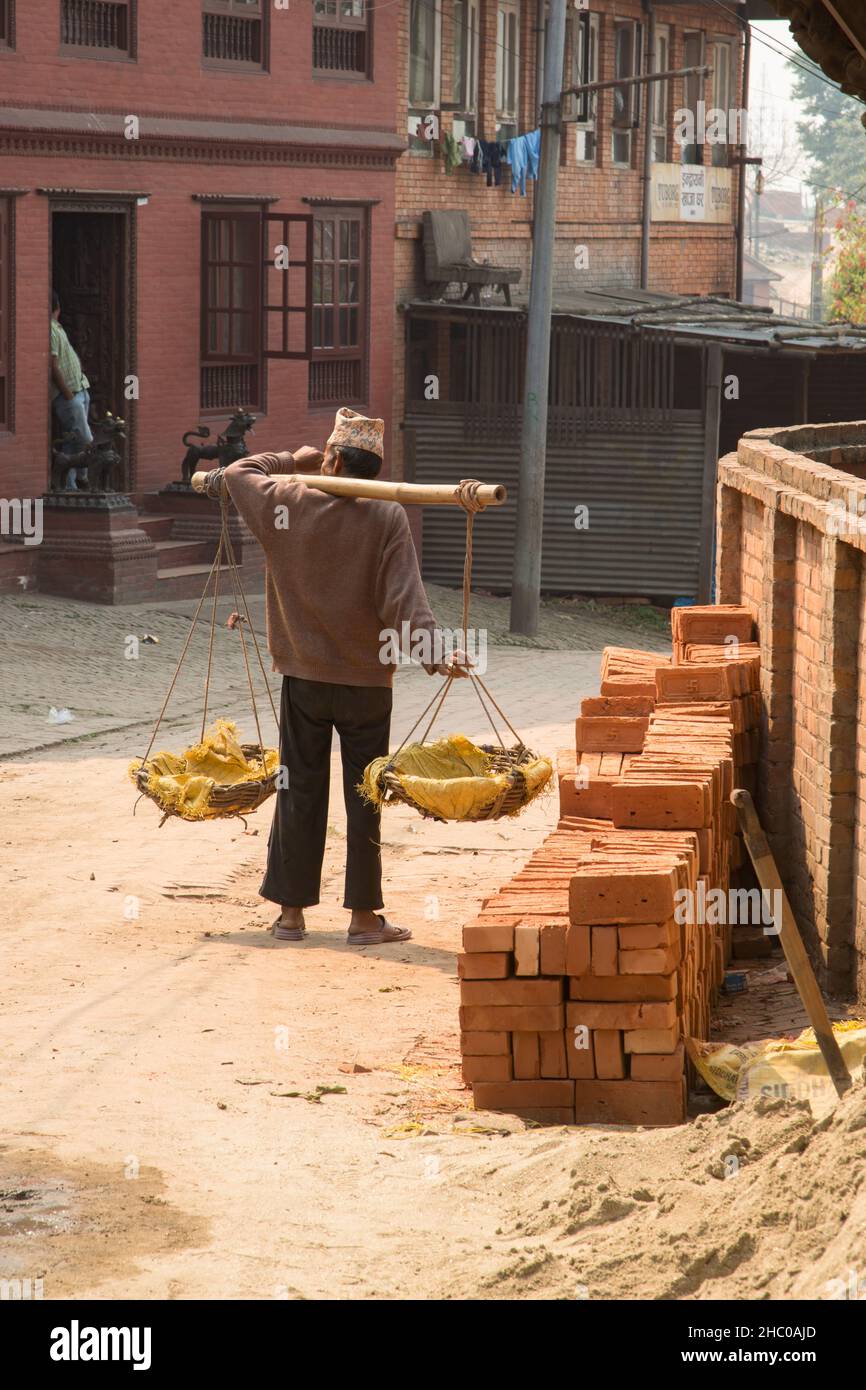 A Nepali man with a shoulder yoke for carrying bricks in the medieval ...