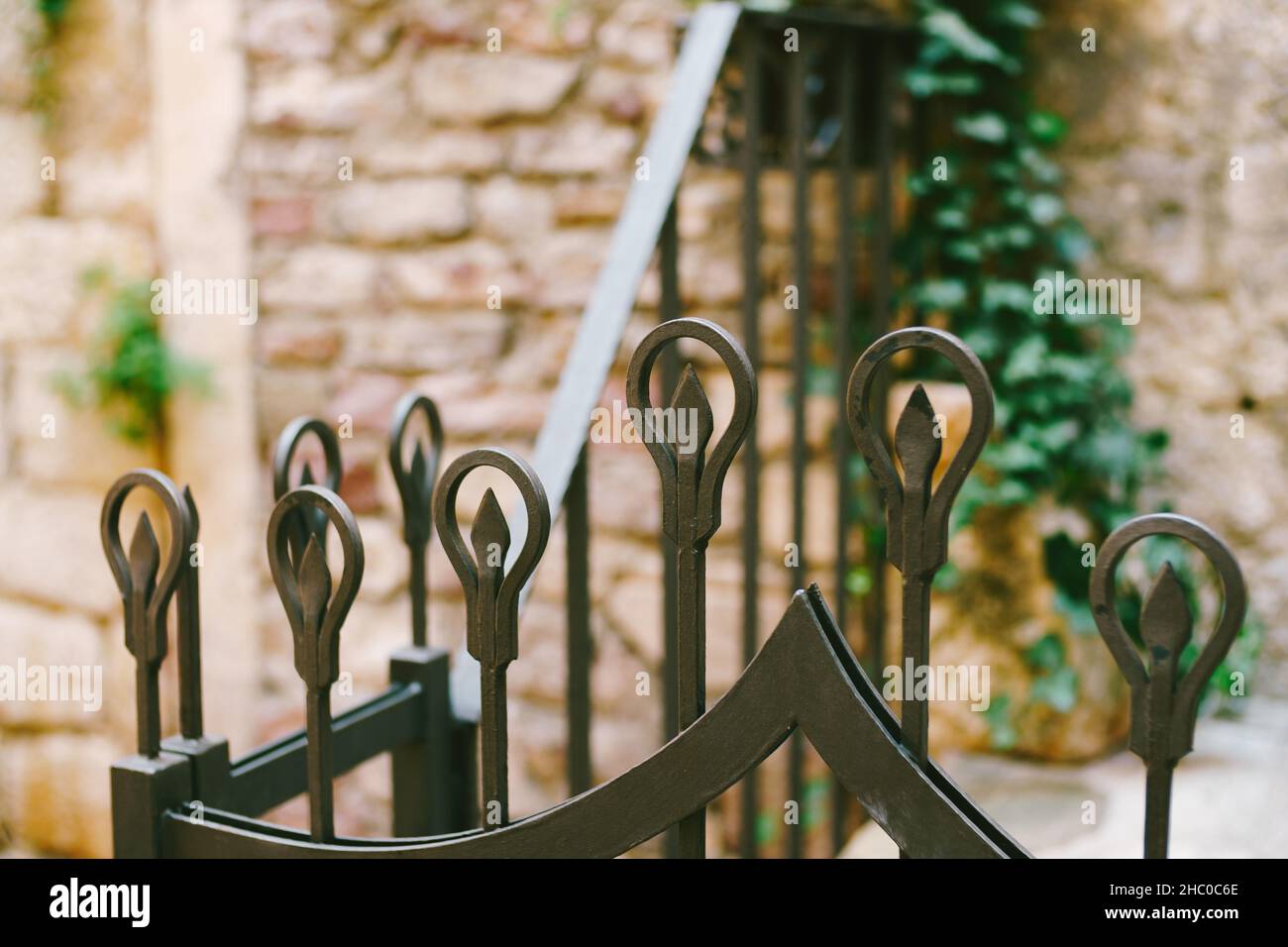 Curly metal prongs on a forged fence Stock Photo - Alamy