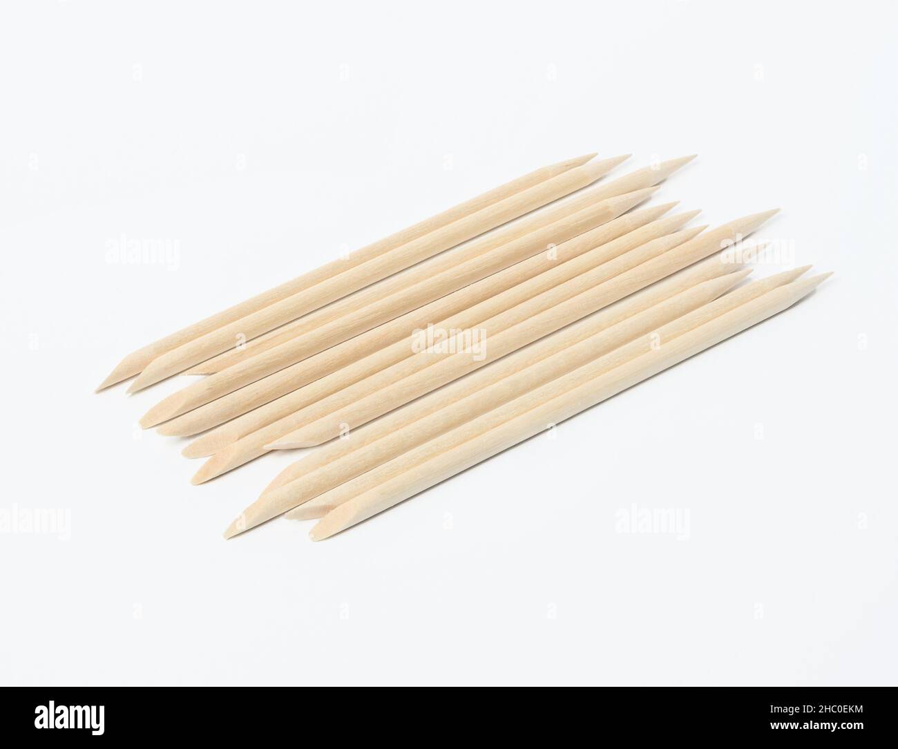 set of orange wooden manicure sticks on white background Stock Photo ...