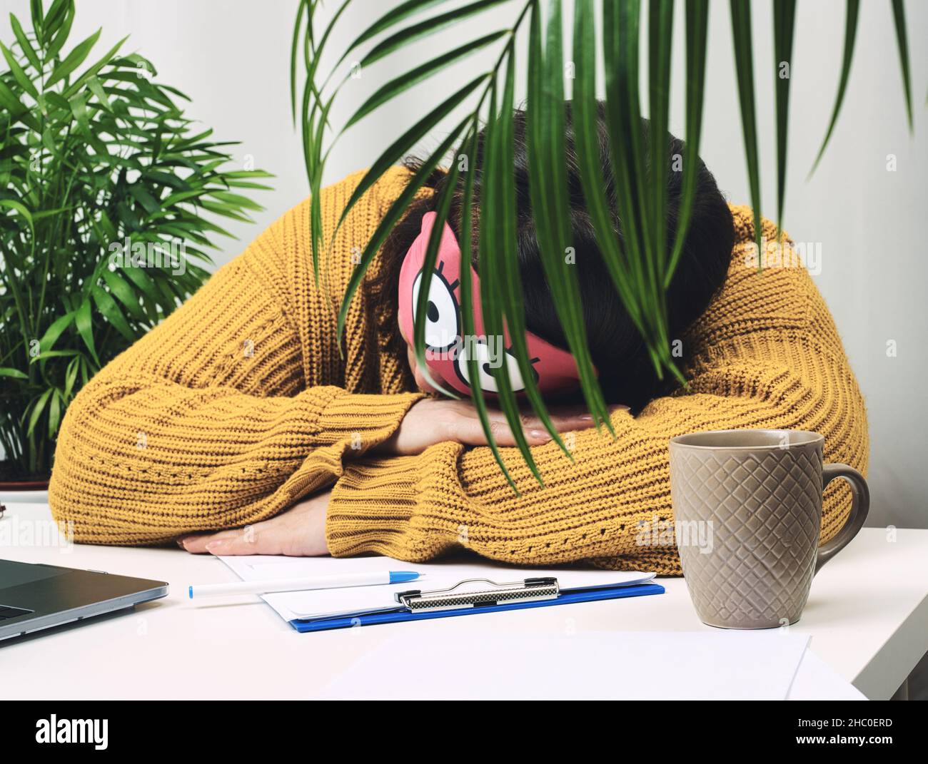 woman 40 years old in an orange sweater sits at a table with a sleep ...